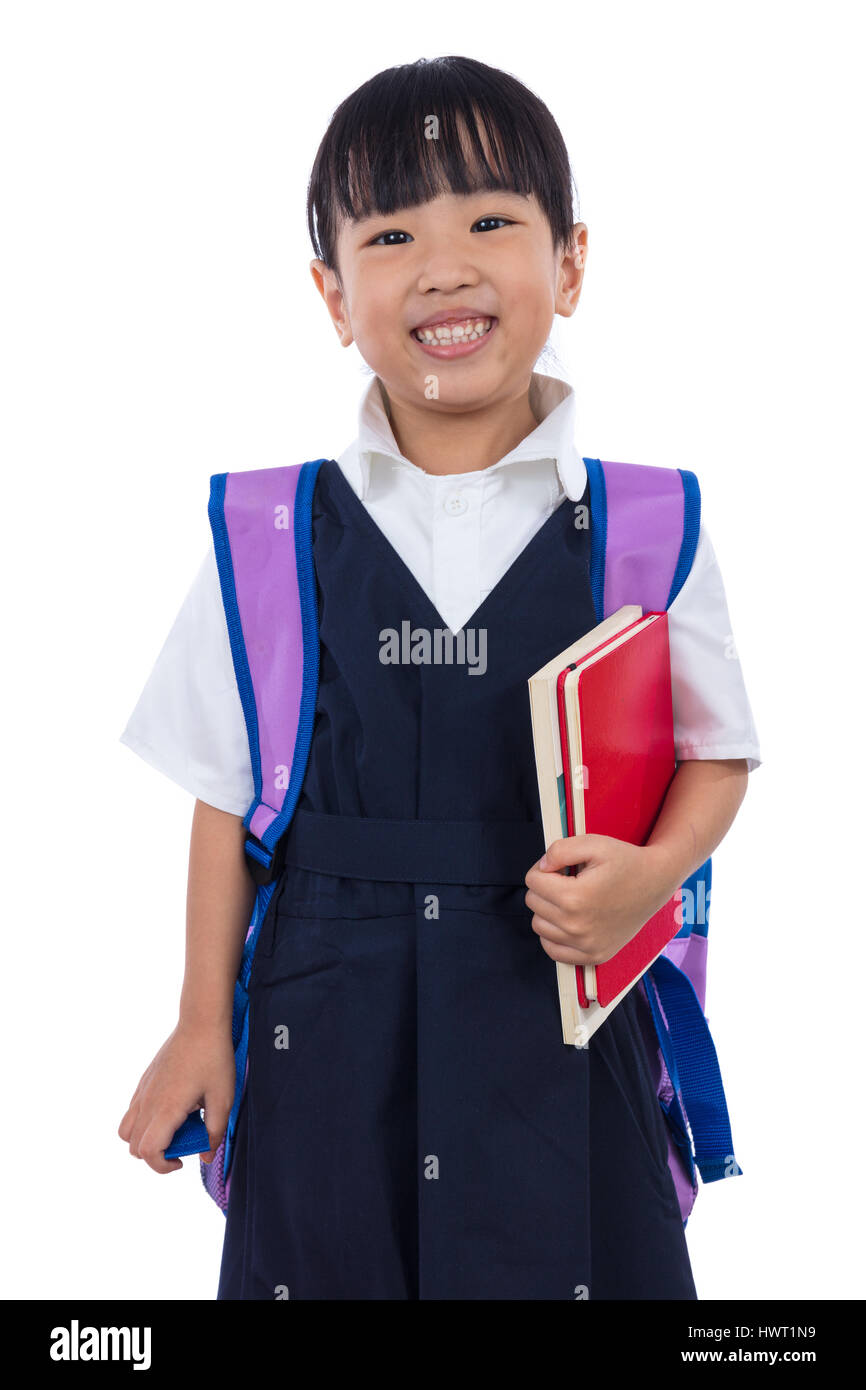 Happy Asian Chinese little primary school girl holding books with ...
