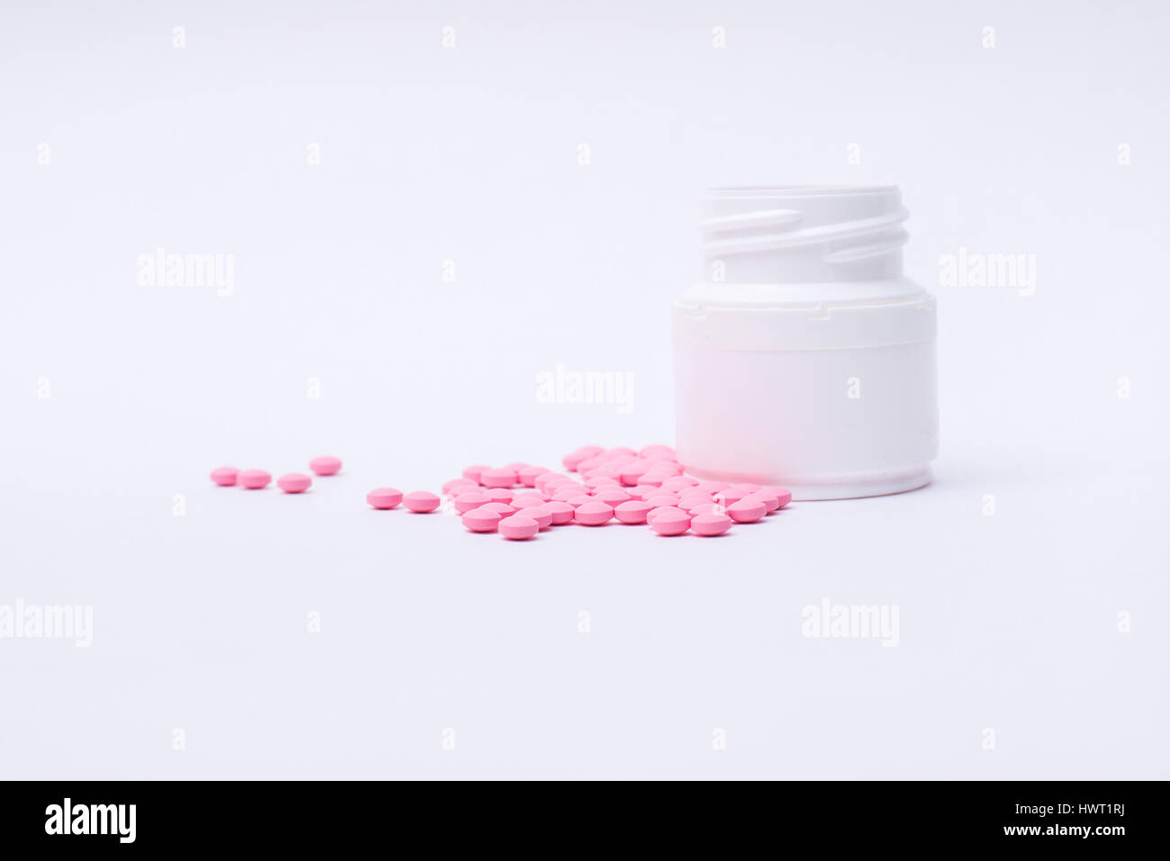 Pink pills and medicine bottle isolated on white background Stock Photo ...