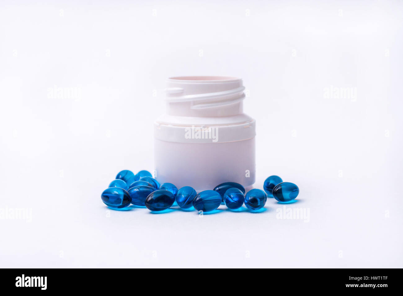 Blue pills and medicine bottle isolated on white background Stock Photo ...