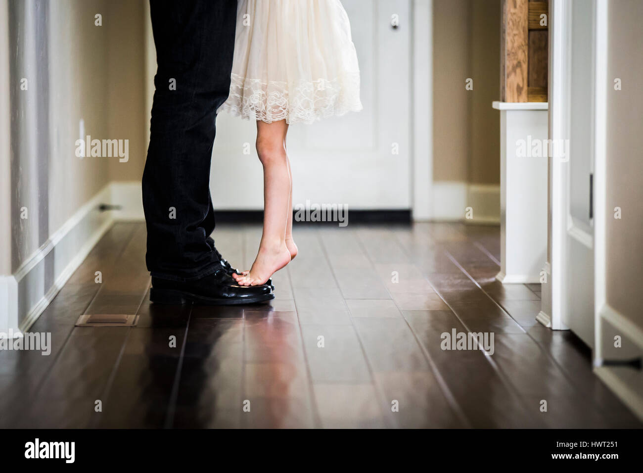 Low section of girl tiptoeing on father's feet at home Stock Photo - Alamy