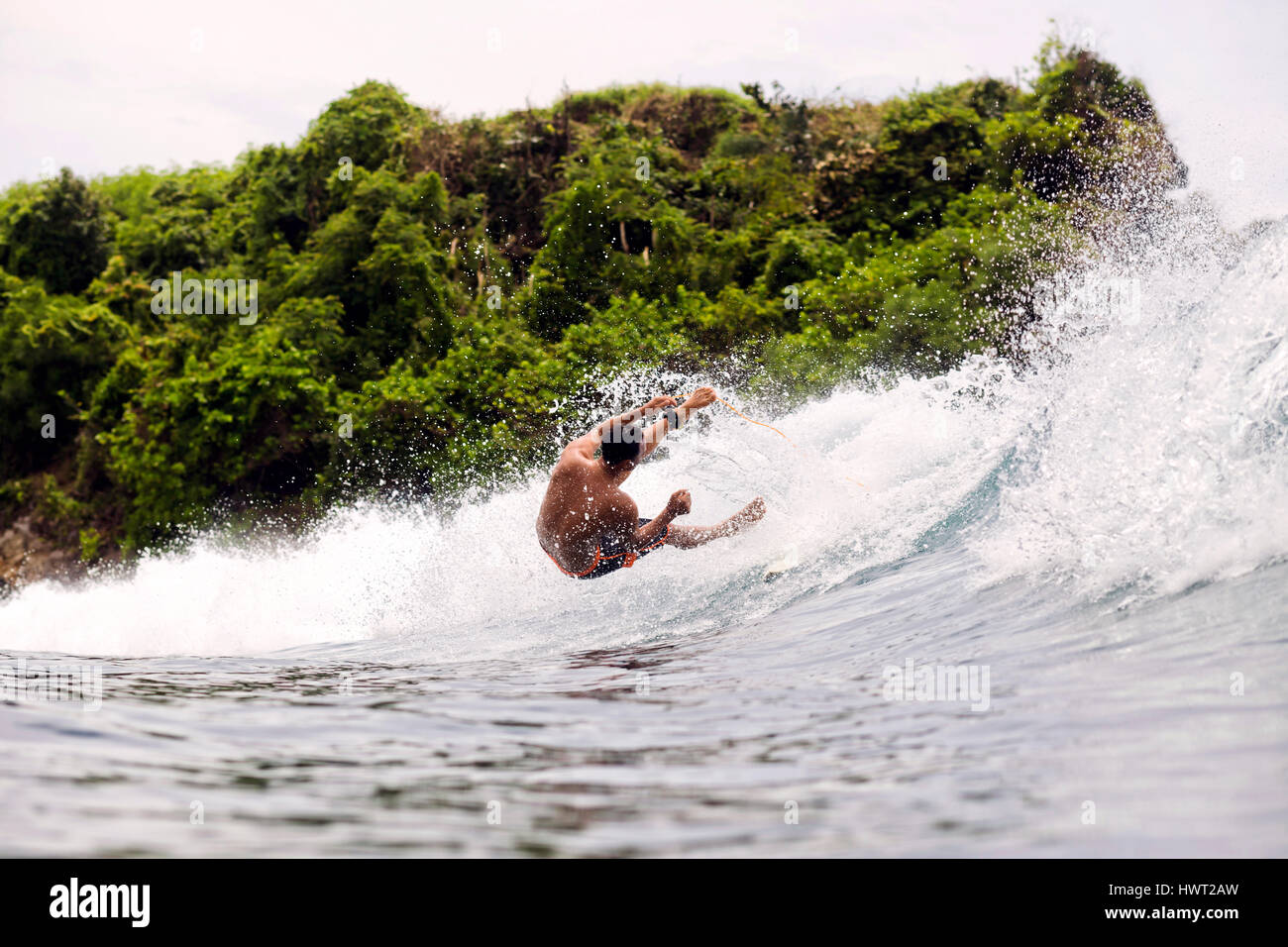 Man falling in water while surfboarding Stock Photo - Alamy