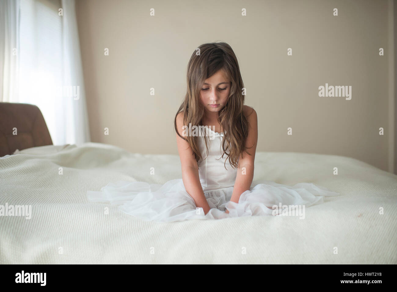 Thoughtful girl relaxing on bed at home Stock Photo - Alamy