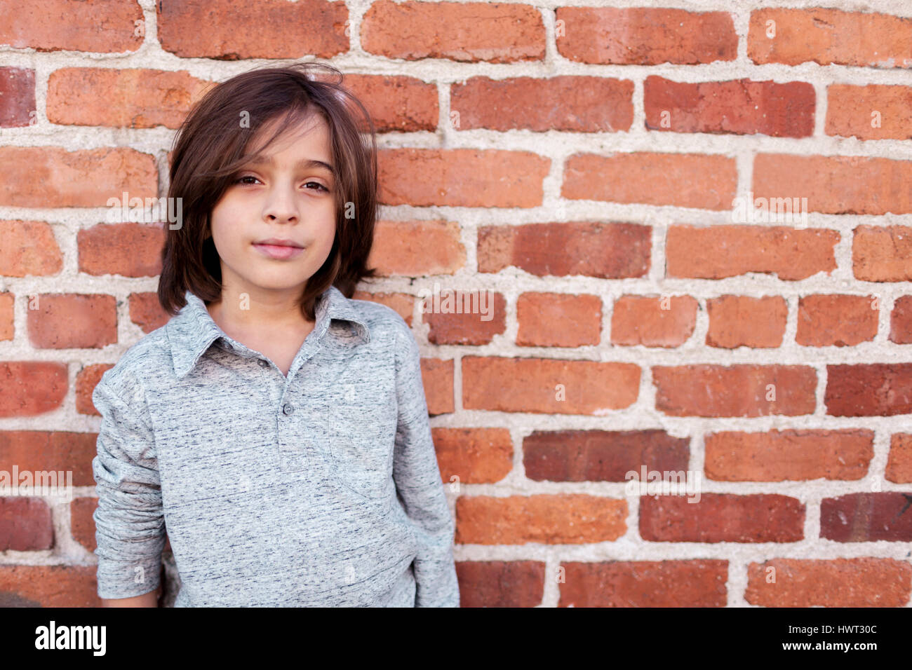 Boy standing up against wall hi-res stock photography and images - Alamy