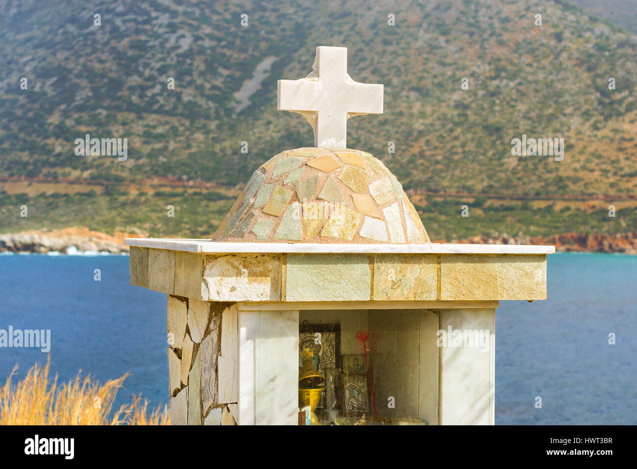 Wayside chapel made of light marble with a stone cross. In the chapel ...