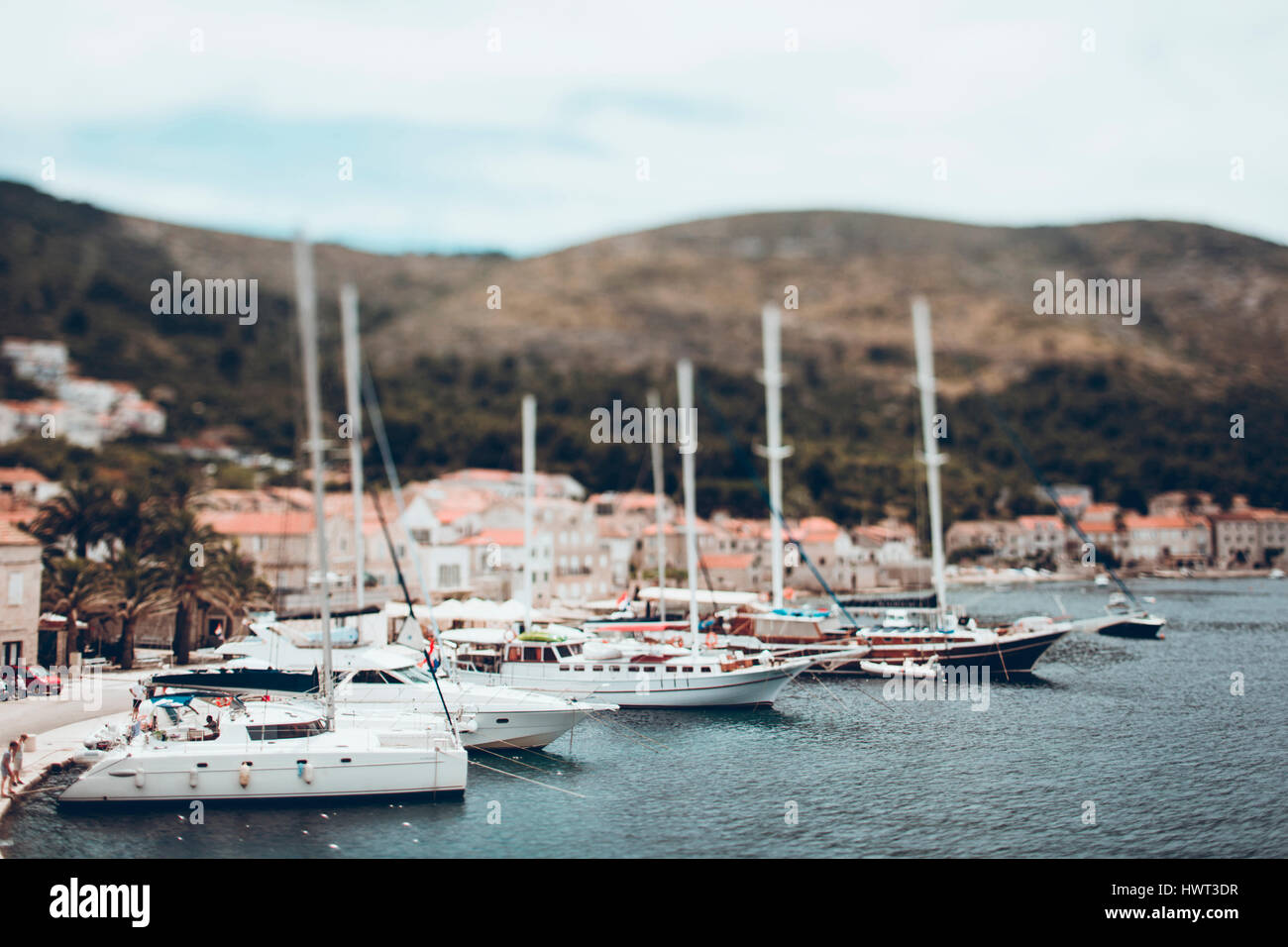 Tilt-shift image of boats moored at lake in town Stock Photo - Alamy