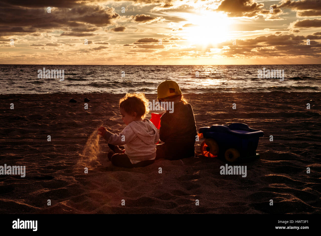 Back view brother sister sitting hi-res stock photography and images ...