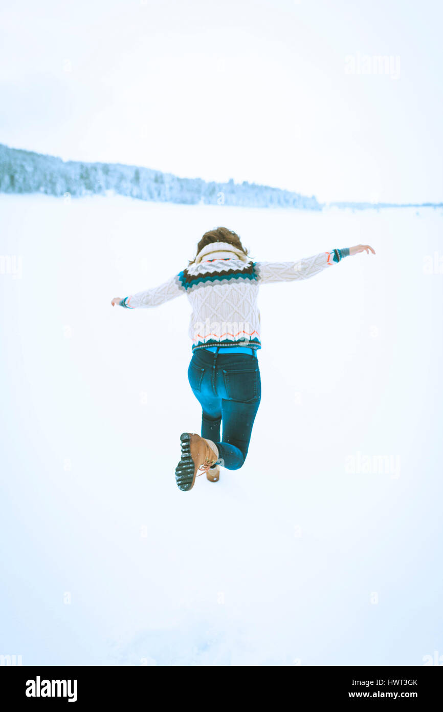 Rear view woman jumping hi-res stock photography and images - Alamy