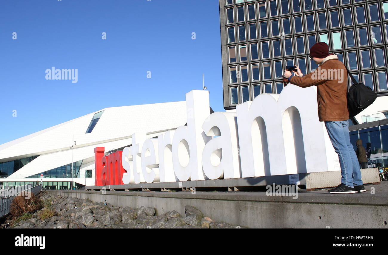 Tourist taking a picture of the I AMsterdam logo, Amsterdam-Noord at IJ ...