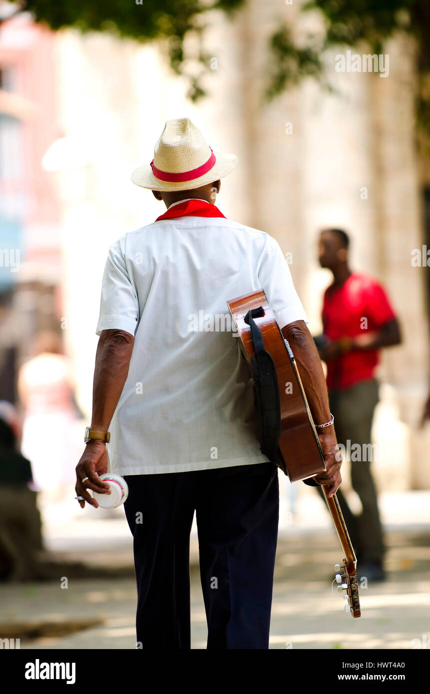 Cuban man wearing traditional panama straw hat playing an acoustic ...