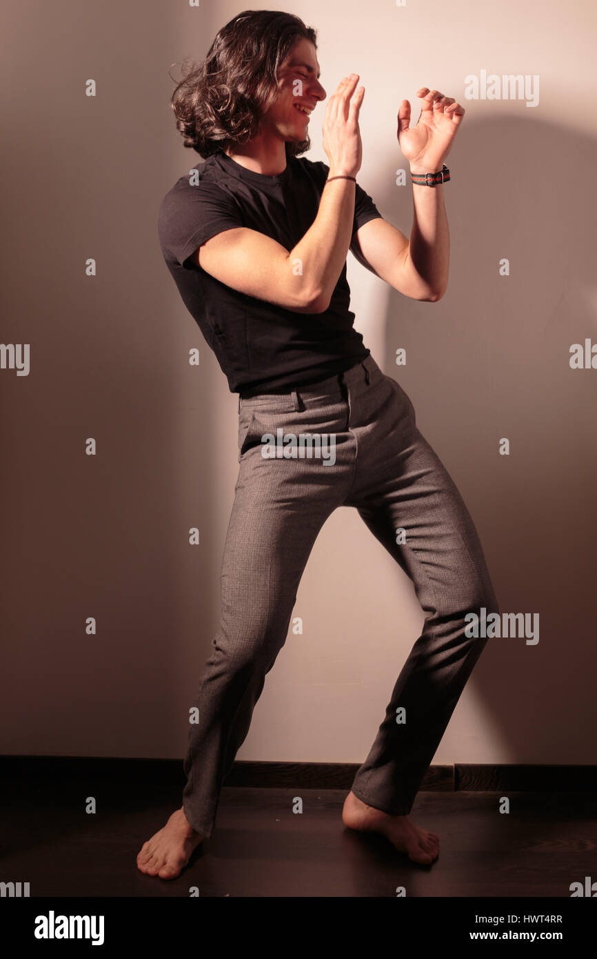 Guy with long hair and in good clothes is having fun Stock Photo - Alamy