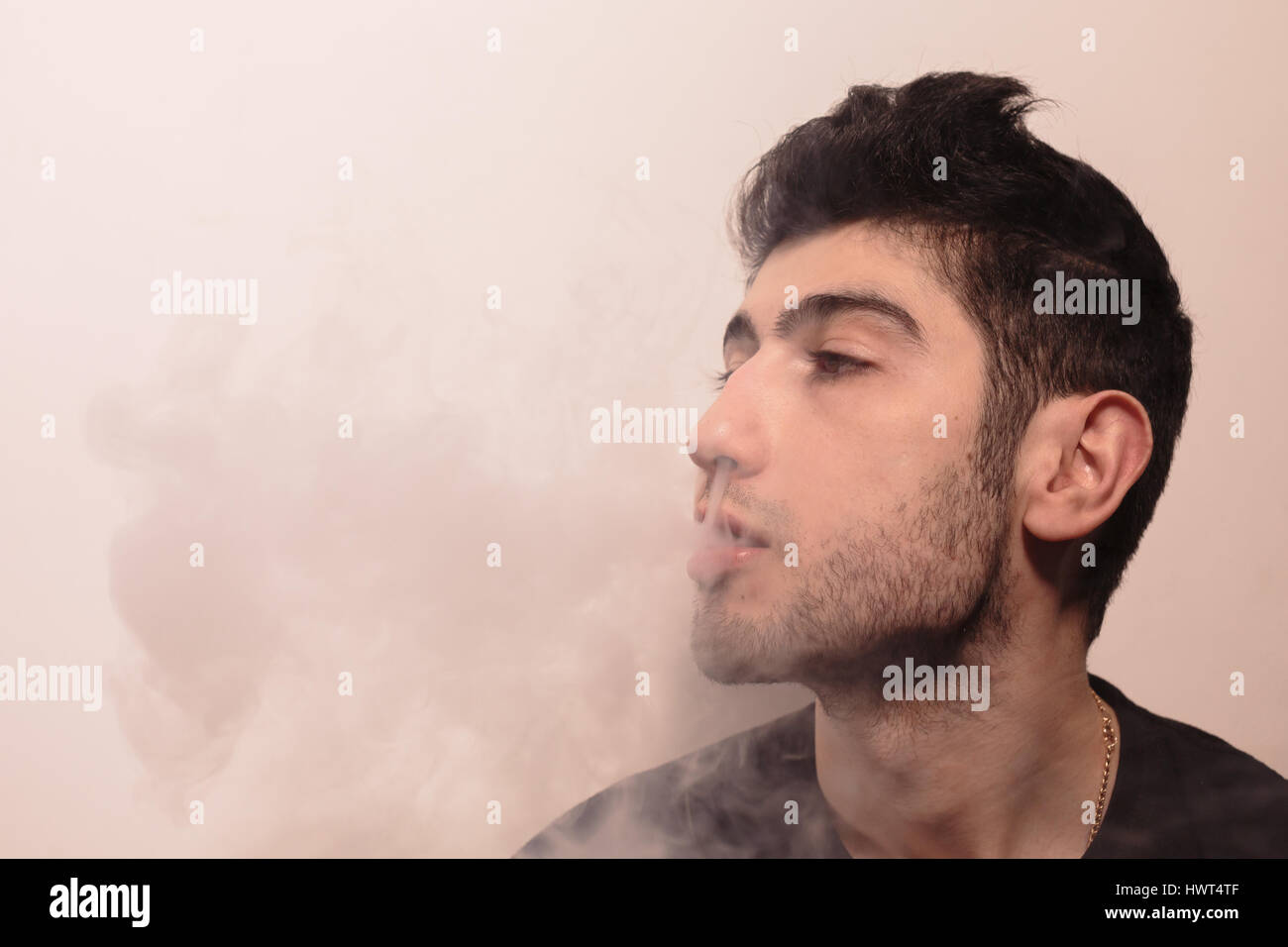 Young man releases a lot of smoke Stock Photo - Alamy
