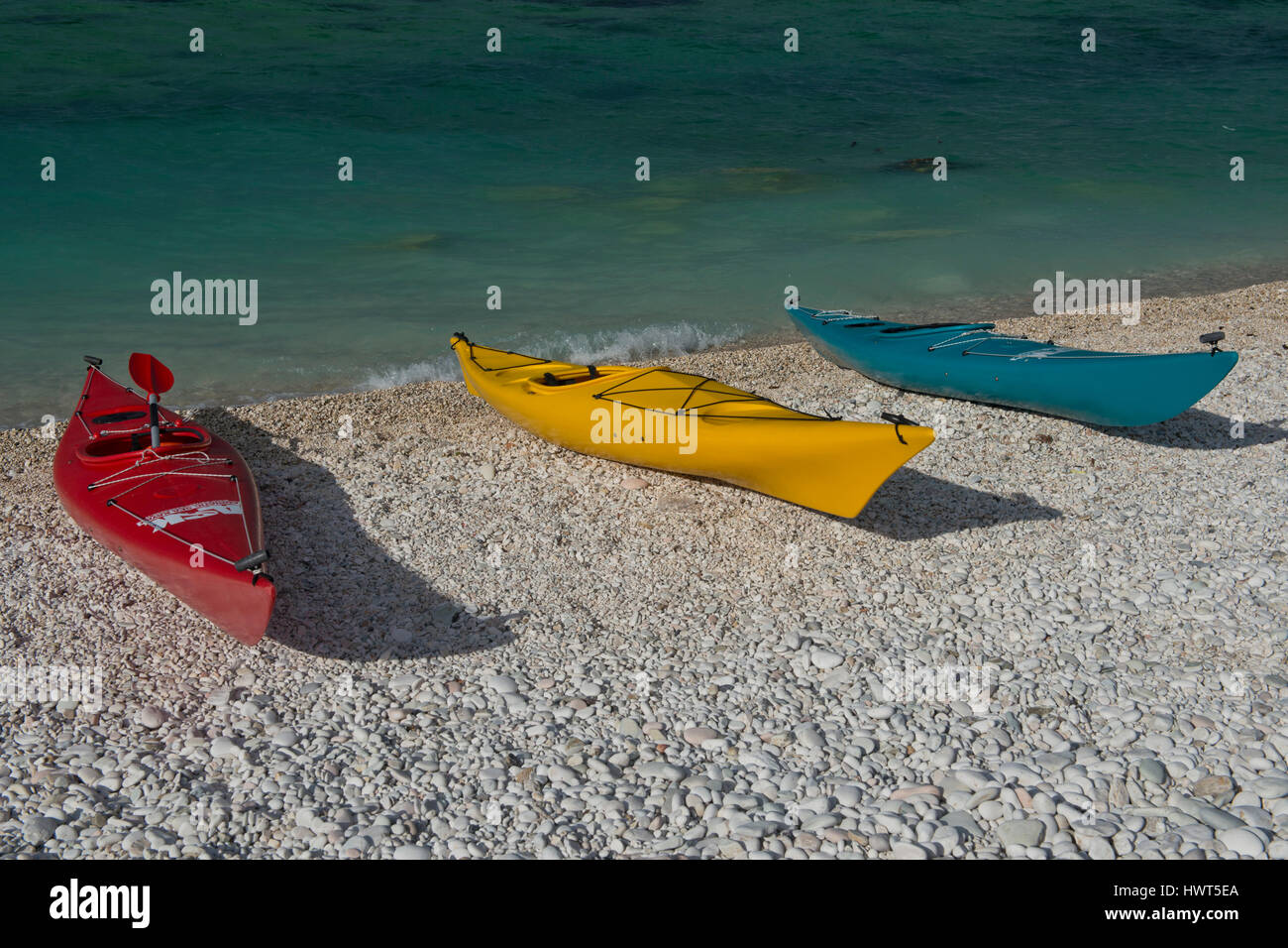 Three colorful canoes lying on the beach of Portonovo Stock Photo - Alamy