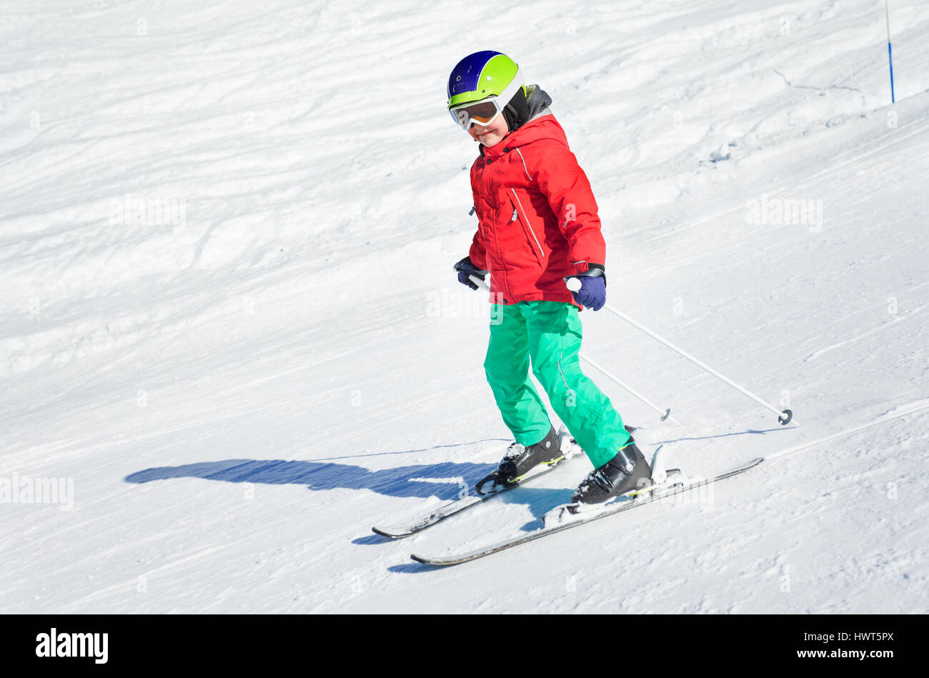 Little skier exercising in alpine resort Stock Photo - Alamy