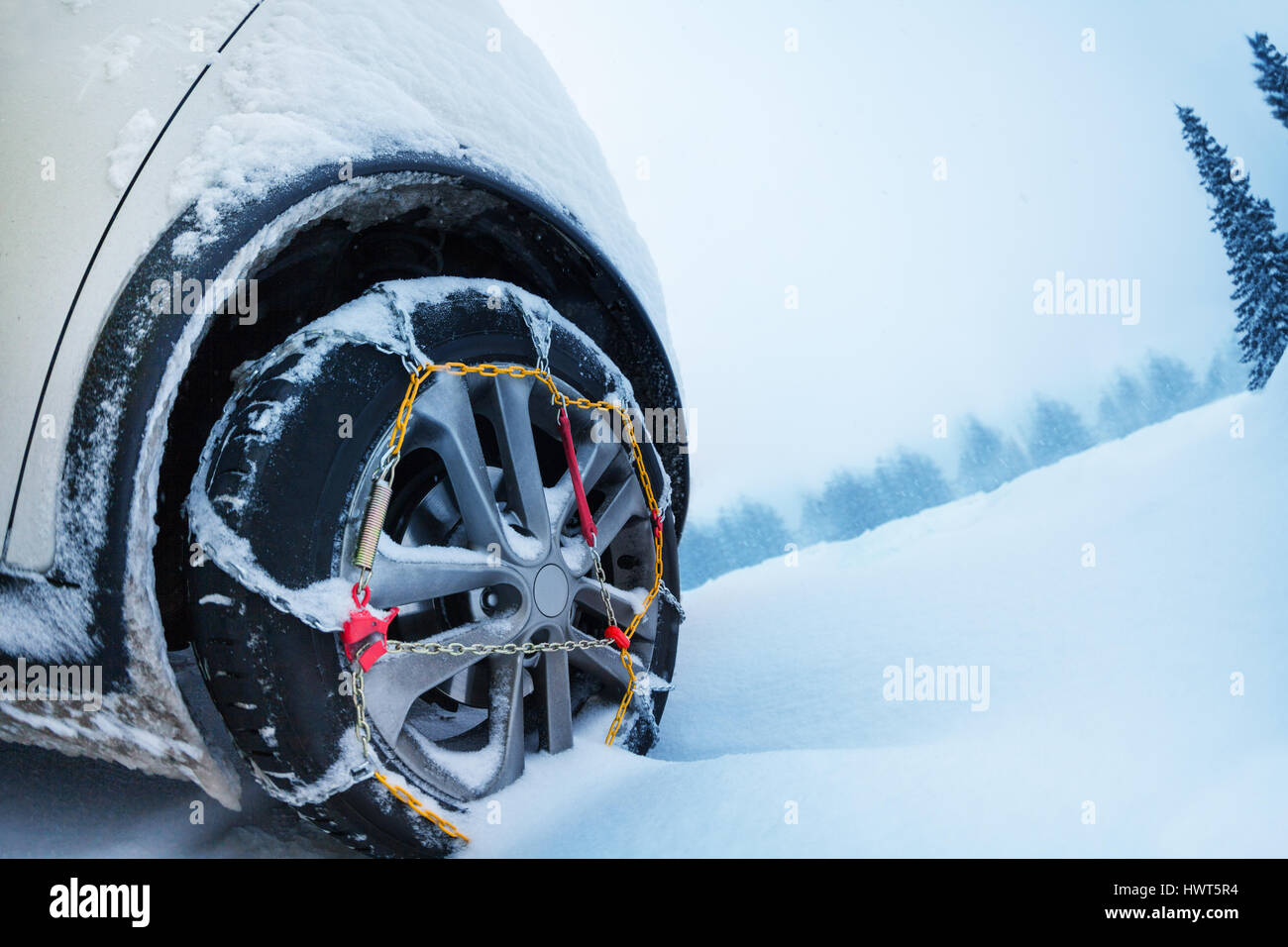 Wheel with snow tire chains on mountain road Stock Photo - Alamy