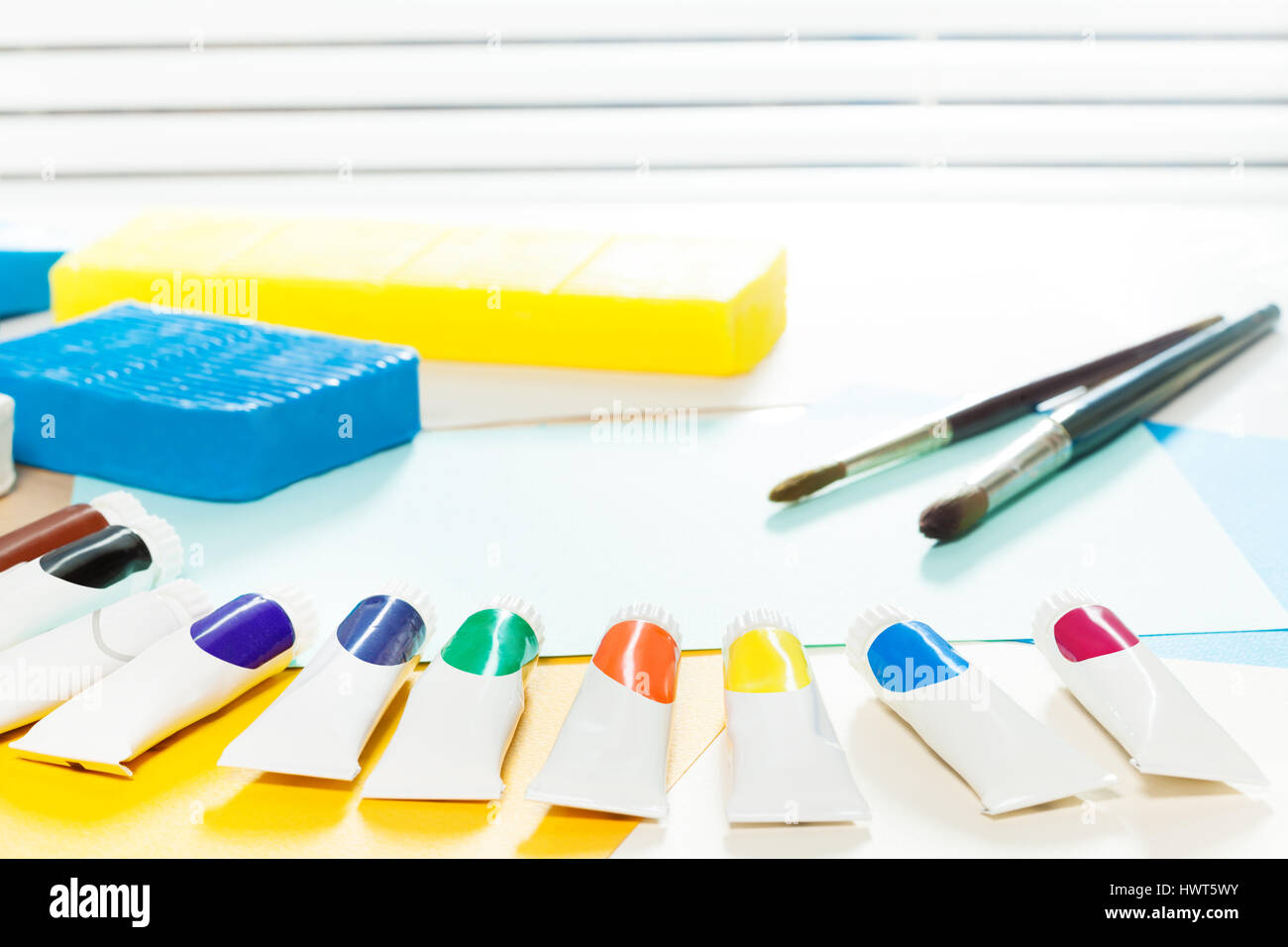 Tubes of paint laying on a table during art lesson Stock Photo - Alamy