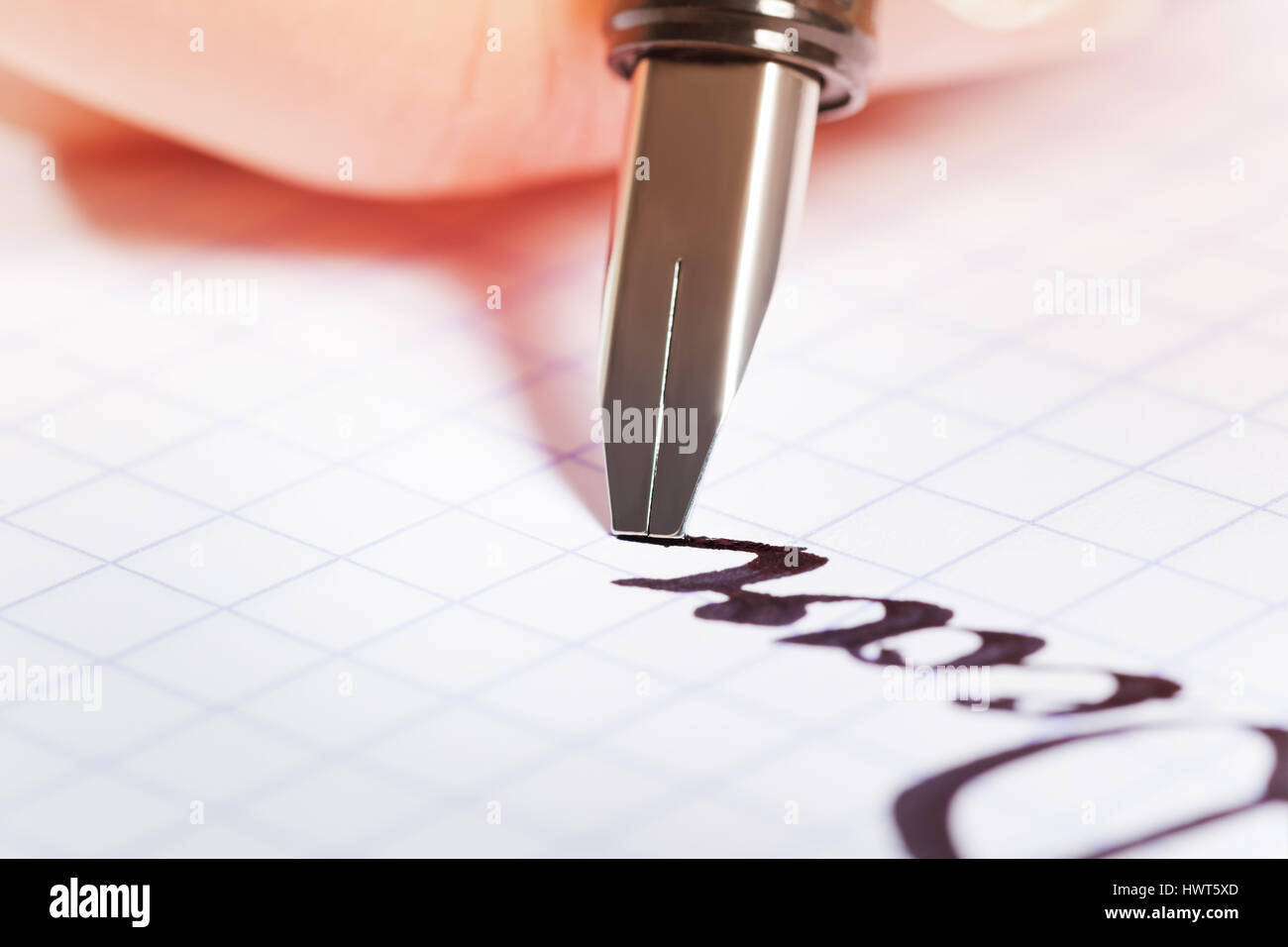 Fountain pen writing the word Dear on graph pad Stock Photo - Alamy