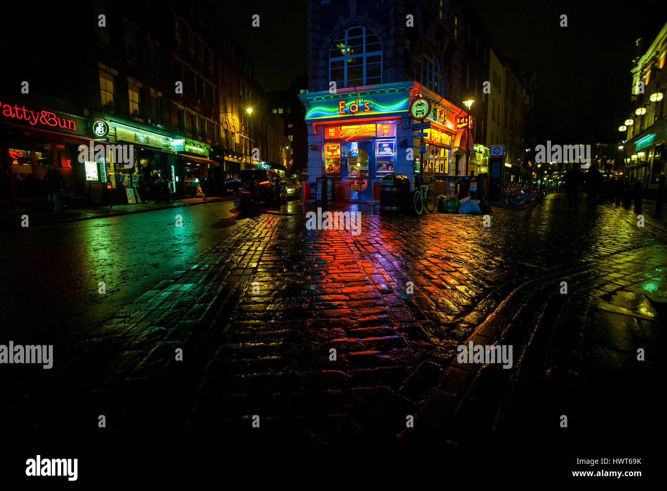 ed's diner neon lights reflected on wet cobbled stone street soho ...
