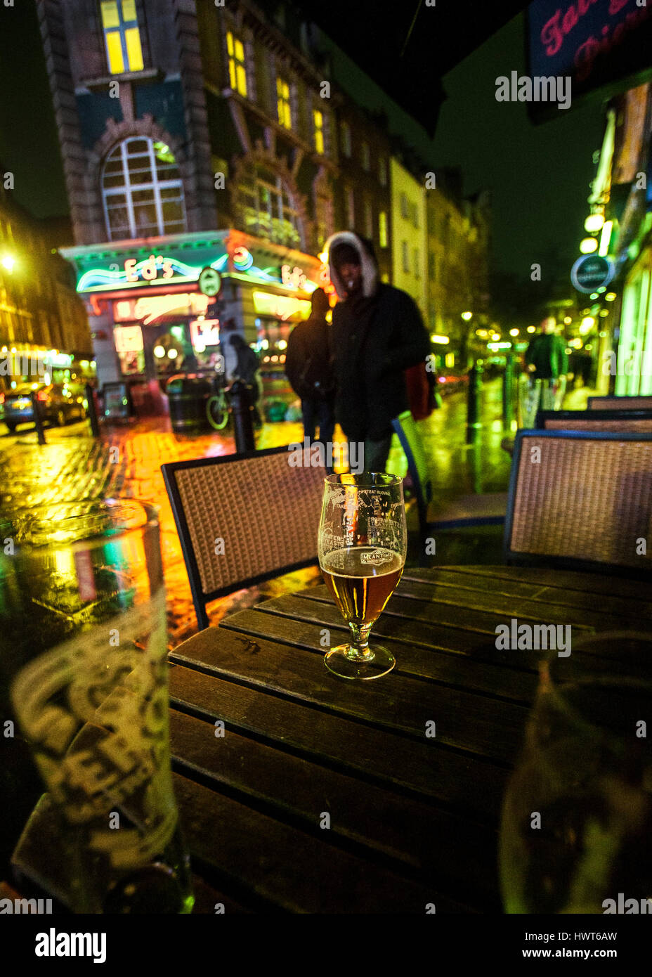glass of beer table soho night rain reflections neon lights of Edds ...