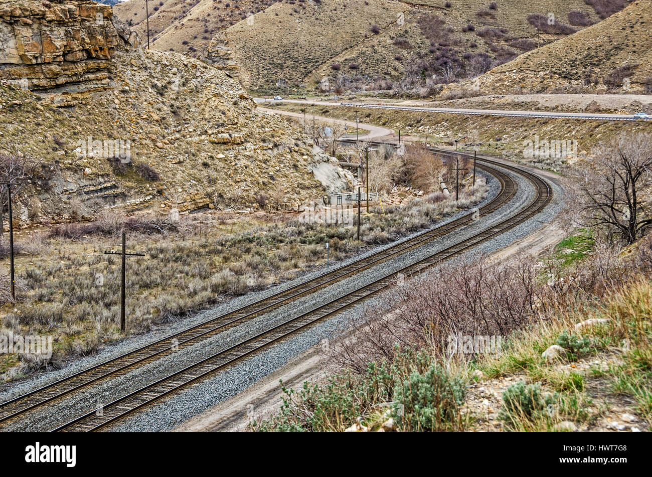 Two sets of tracks winding around a curve and crossing a small road ...