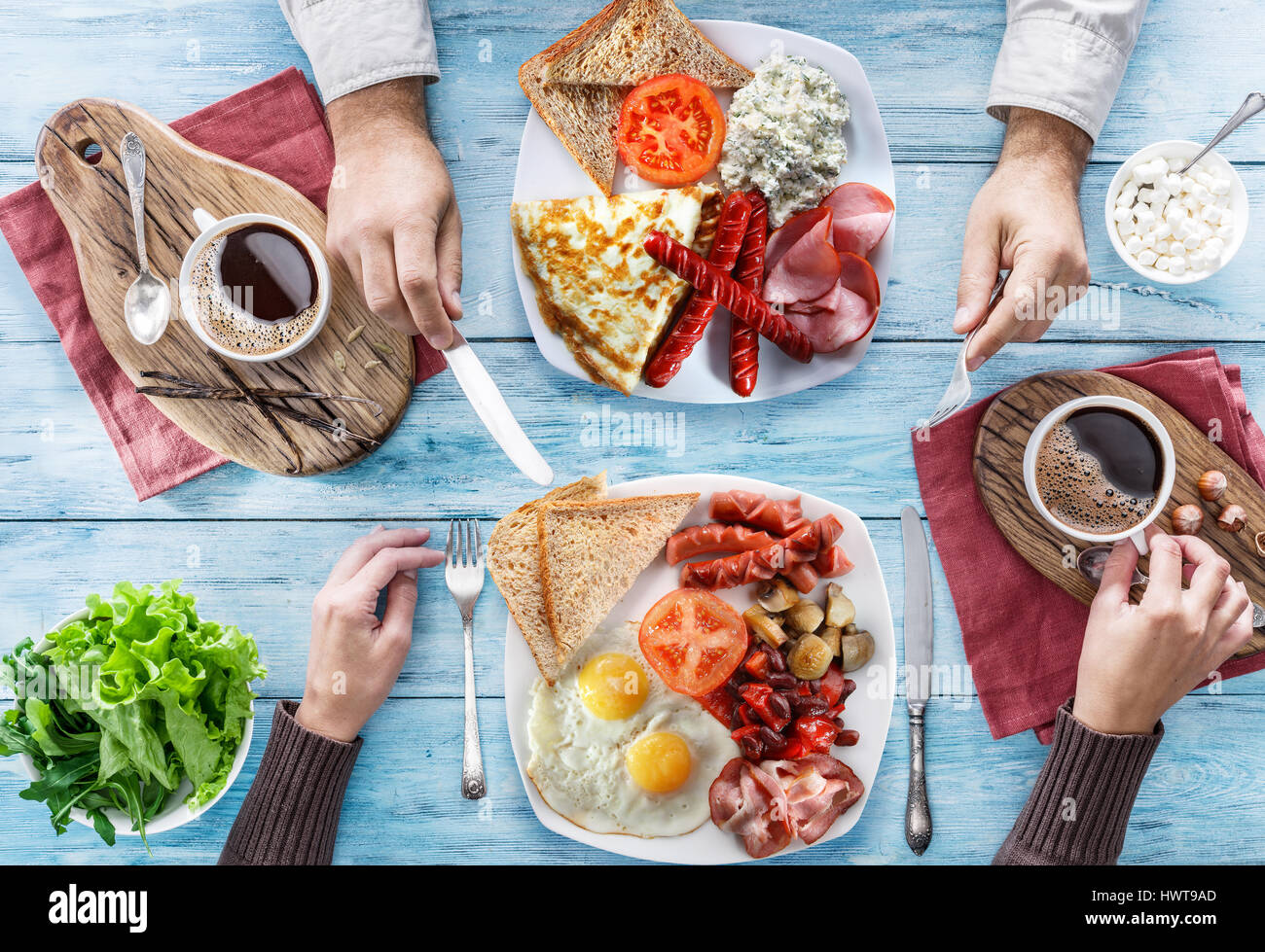 Traditional breakfast at home. Top view of table and people who having ...