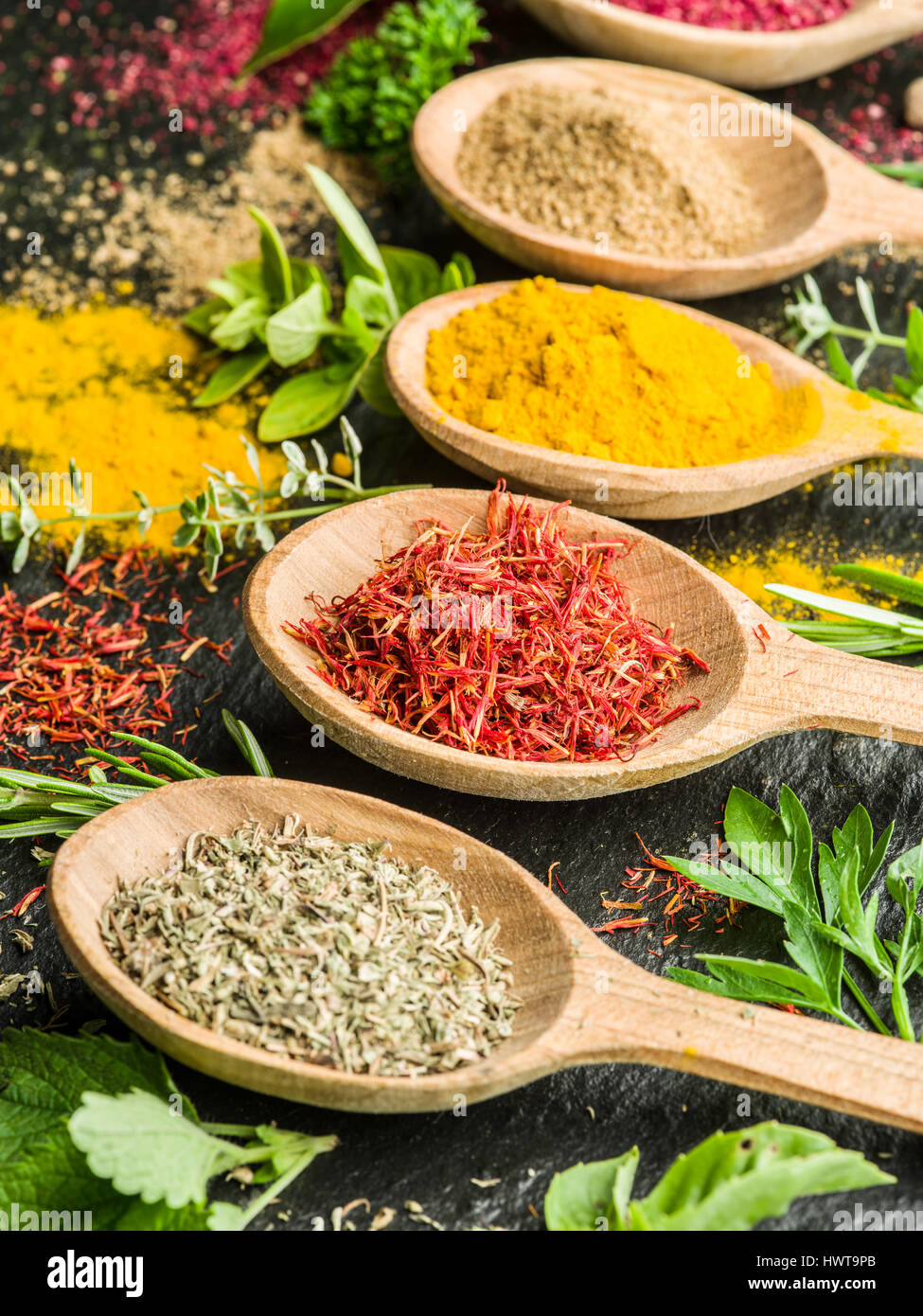 Assortment of colorful spices in the wooden spoons Stock Photo - Alamy