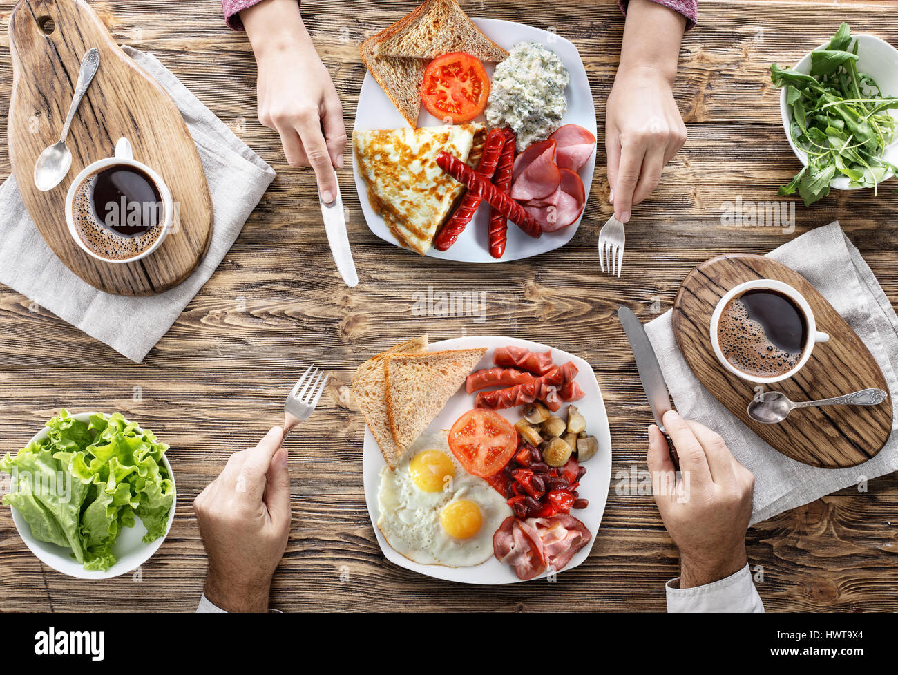 Traditional breakfast at home. Top view of table and people who having ...