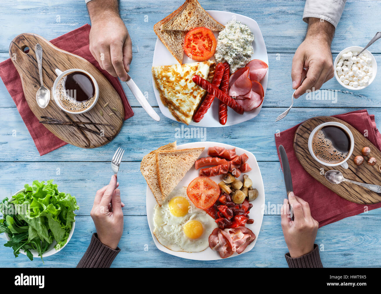 Traditional breakfast at home. Top view of table and people who having ...