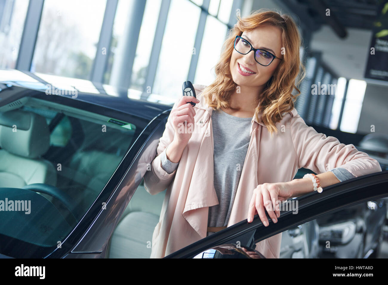 Confident woman prepared for driving by new car Stock Photo - Alamy
