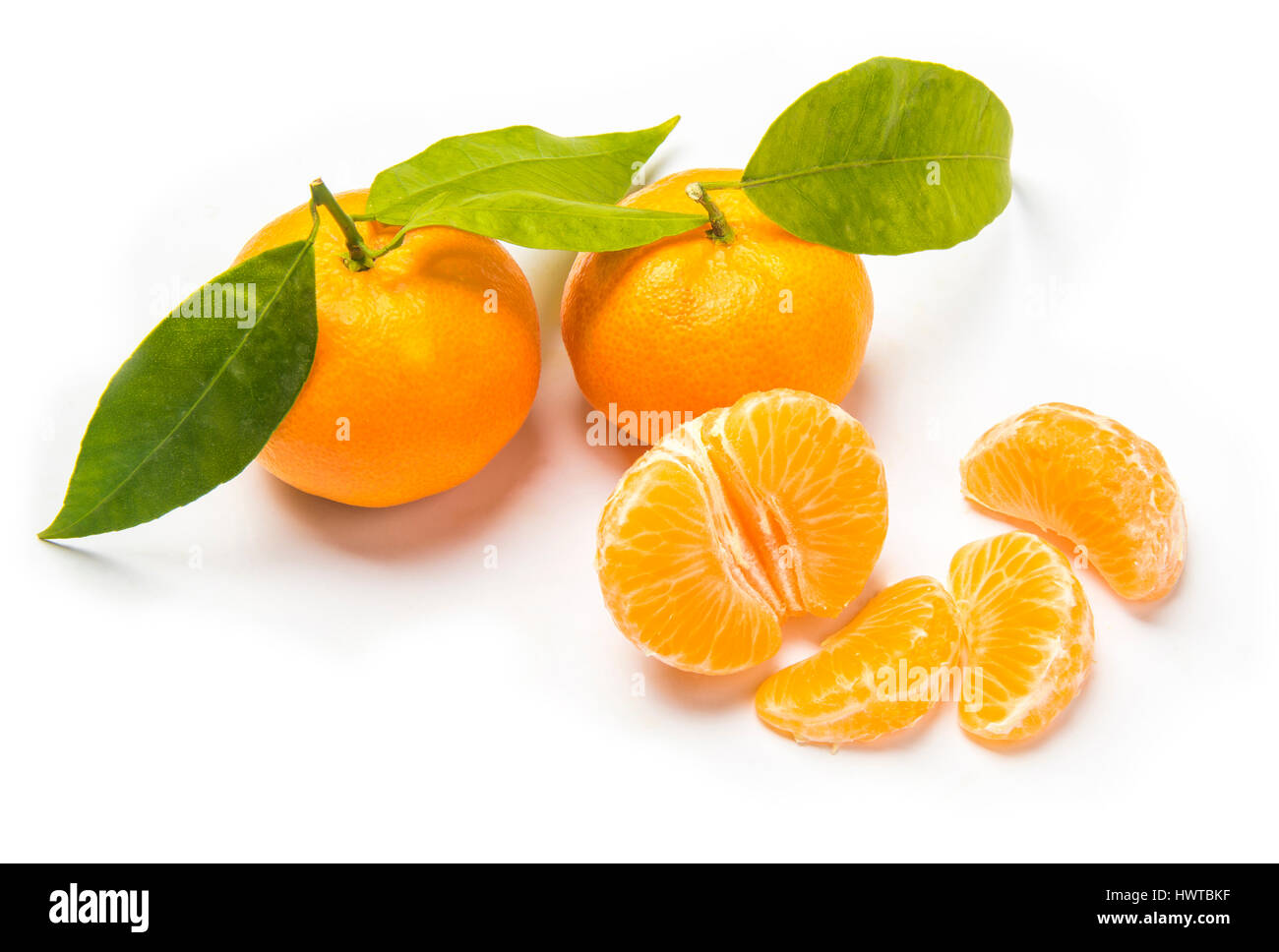 piece of fruit of tangerine with leaves and guys Stock Photo - Alamy