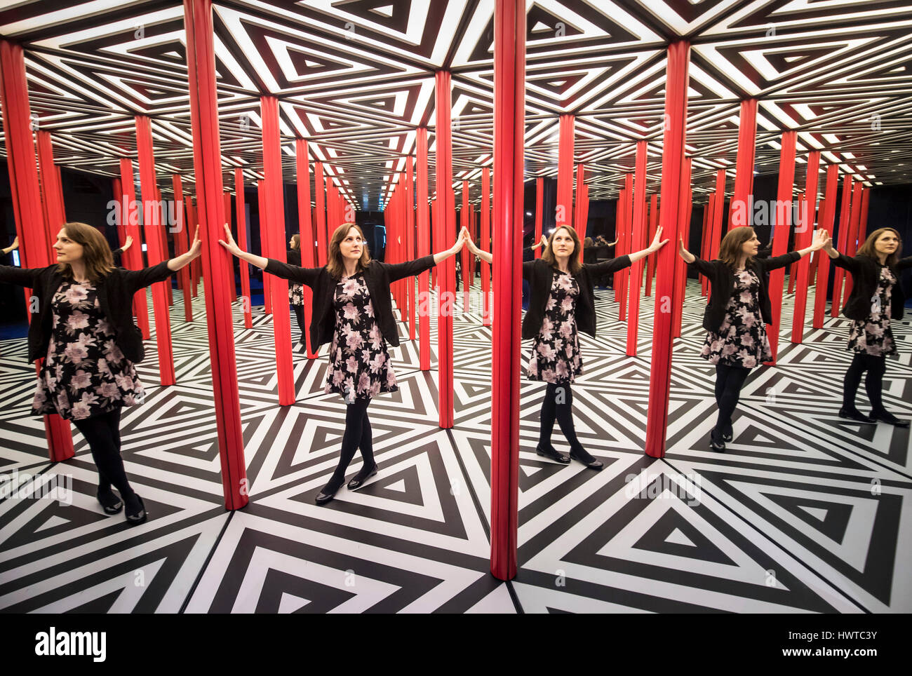 Museum employee Lorna Williams is reflected in mirrors as she views an ...