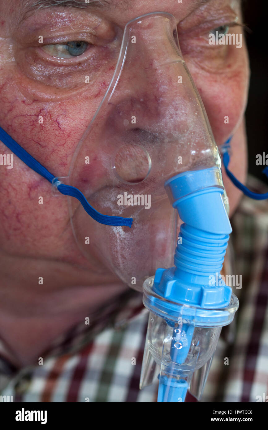Old man using a nebuliser Stock Photo - Alamy