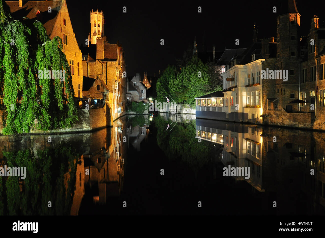 beautiful Brugge night view with canal reflections of buildings and ...