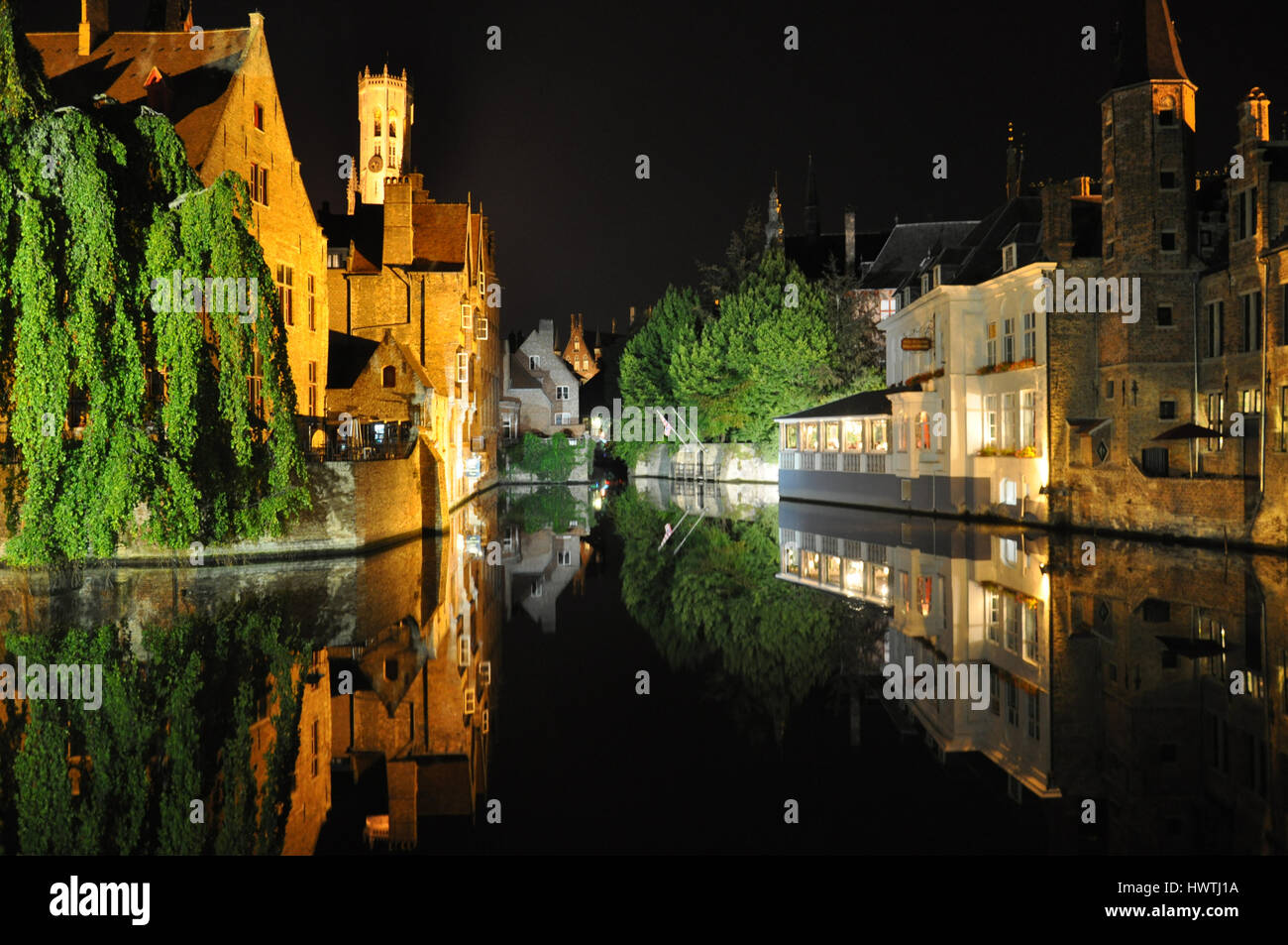 beautiful Brugge night view with canal reflections of buildings and ...
