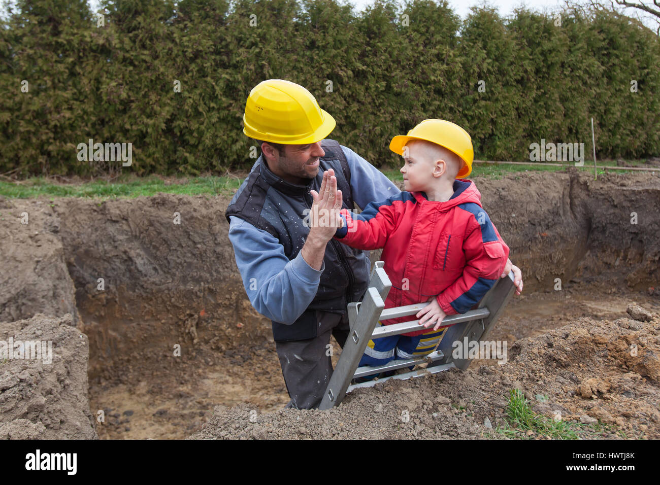 Father and son working on building a house Stock Photo - Alamy