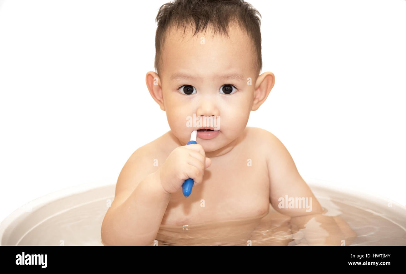 baby boy brushing teeth by blue color tooth brush,isolated on white ...