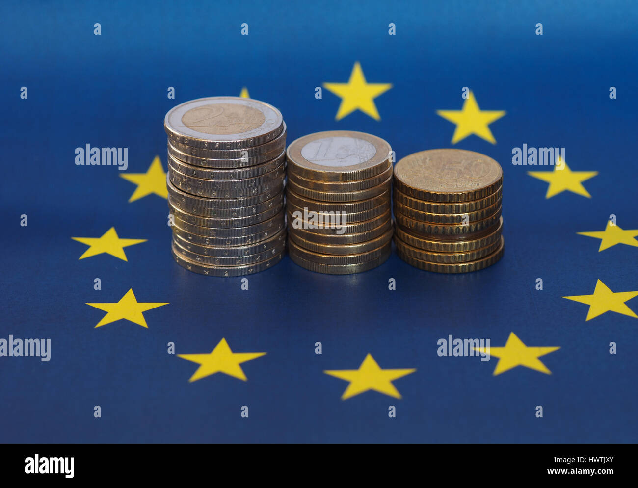 Euro coins (EUR), currency of European Union over flag of Europe Stock ...