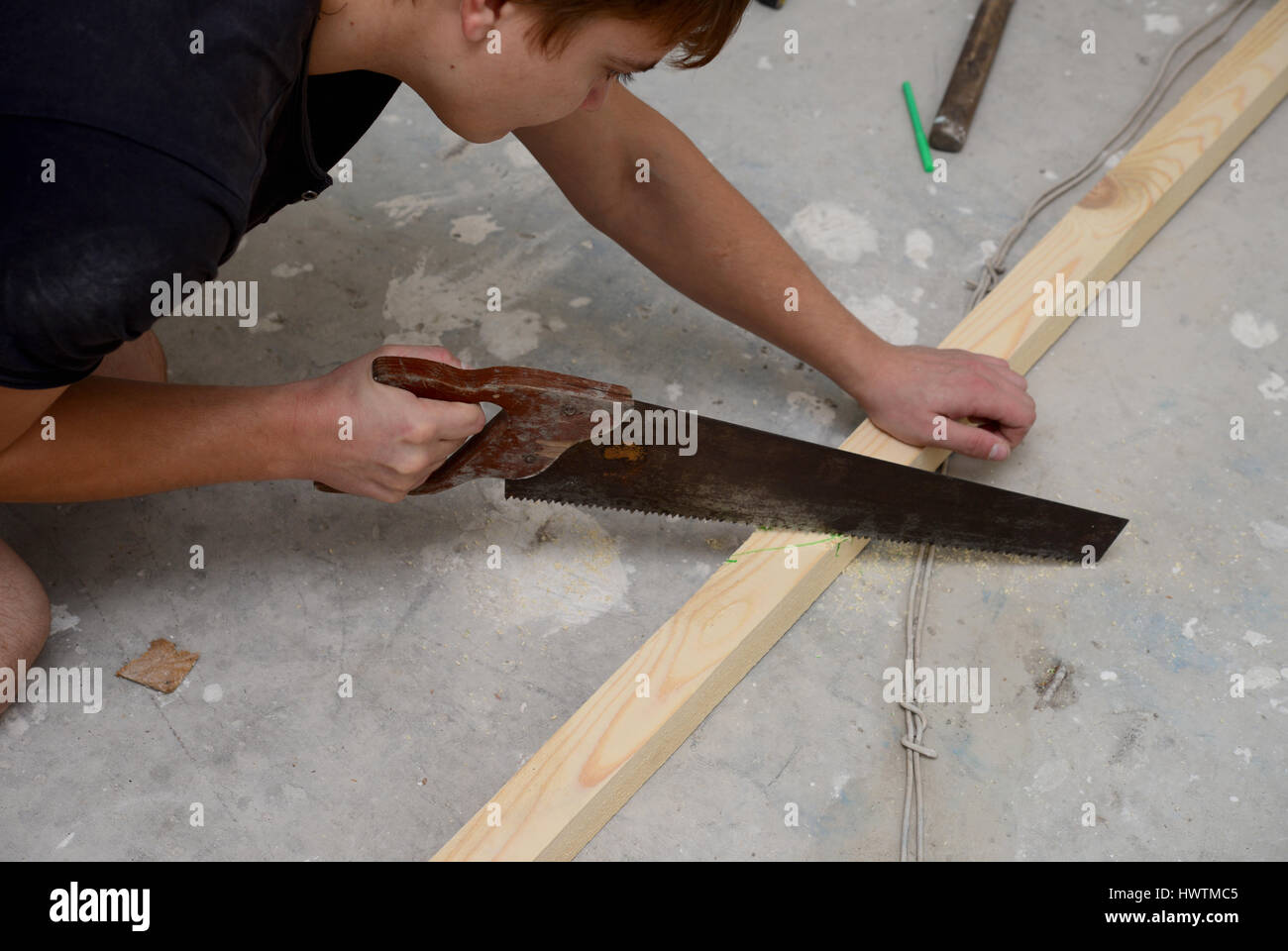 detail of a man cutting wood with a small hand saw Stock Photo - Alamy
