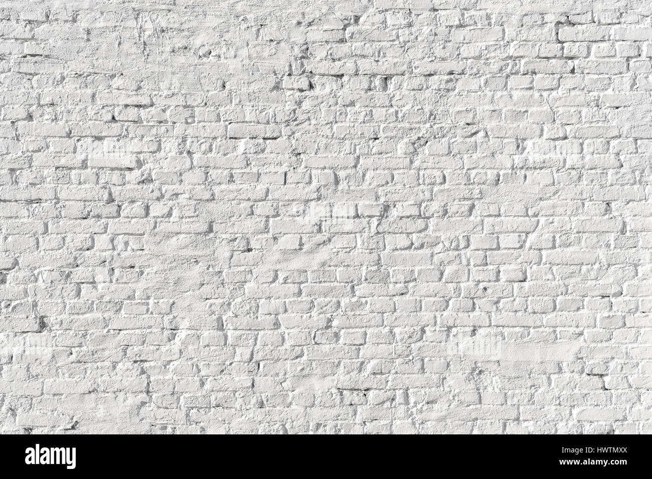 White painted uneven brick wall background Stock Photo - Alamy
