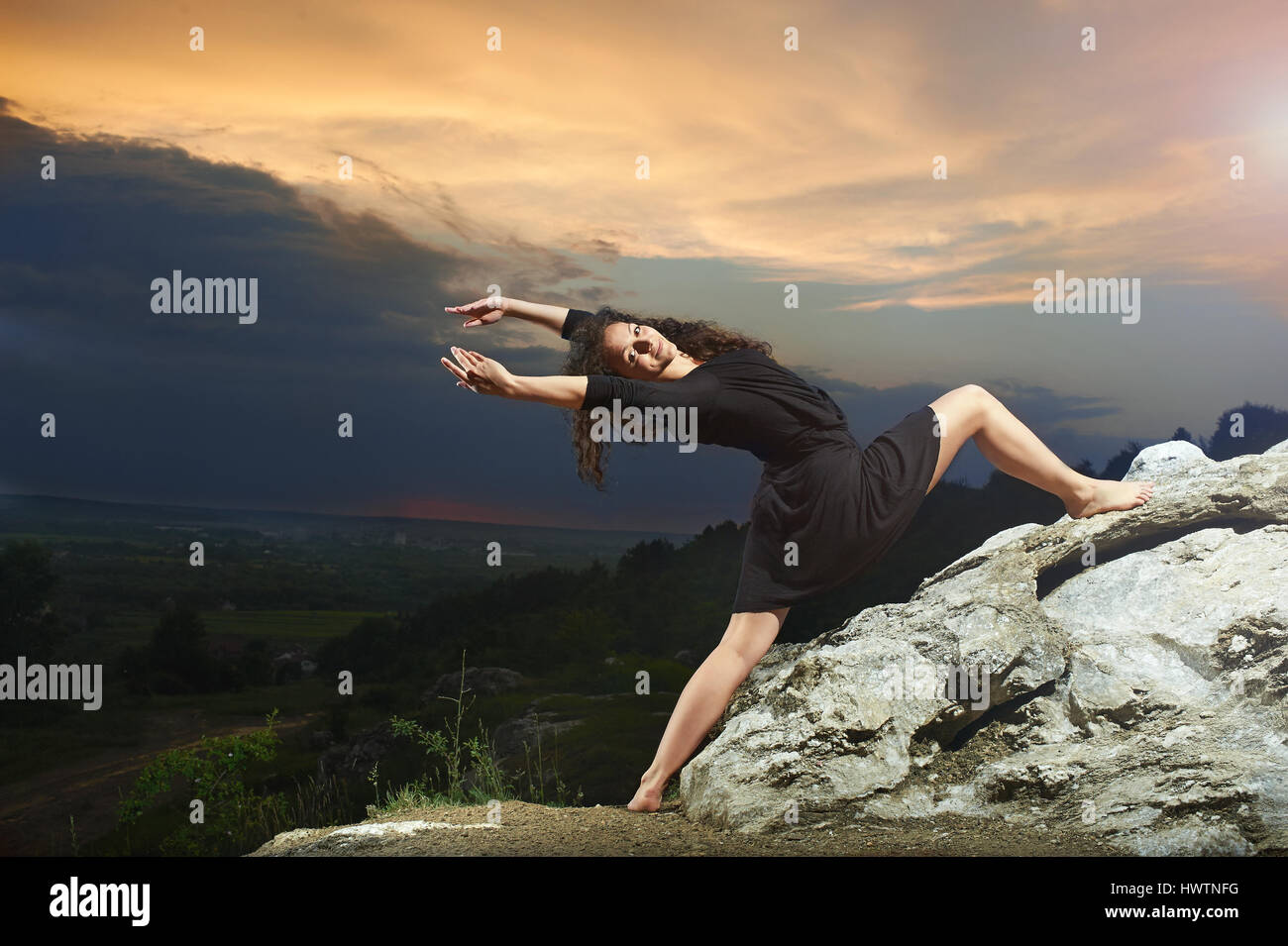 young, curly dancing girl dancing in the mountains Stock Photo - Alamy