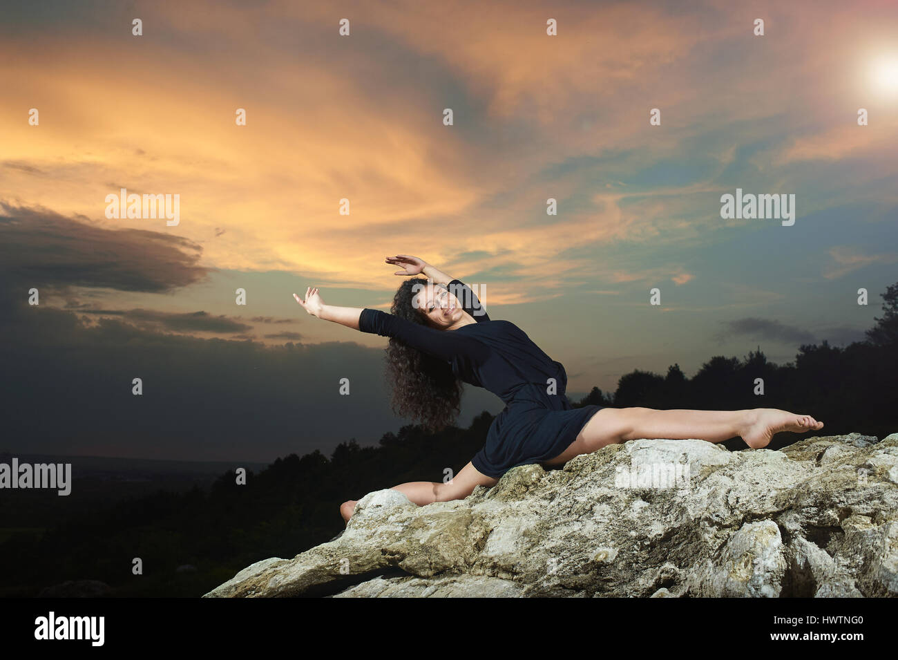 young, curly dancing girl - performs split Stock Photo - Alamy