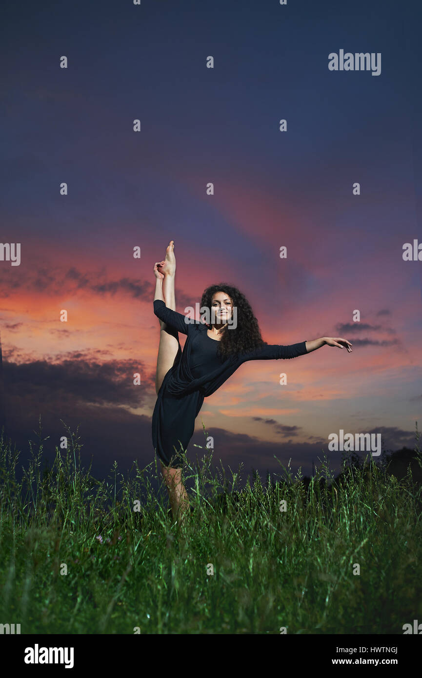 athletic, curly dancer performs vertical side splits Stock Photo - Alamy