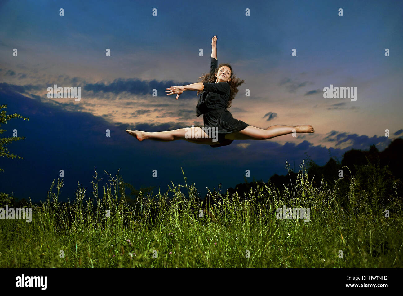 pretty, young, smiling dancer performs splits in the air Stock Photo ...