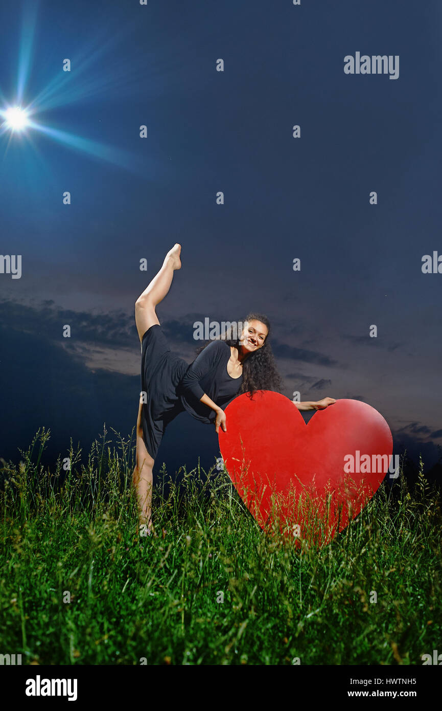 smiling, curly dancer performs vertical side splits Stock Photo - Alamy