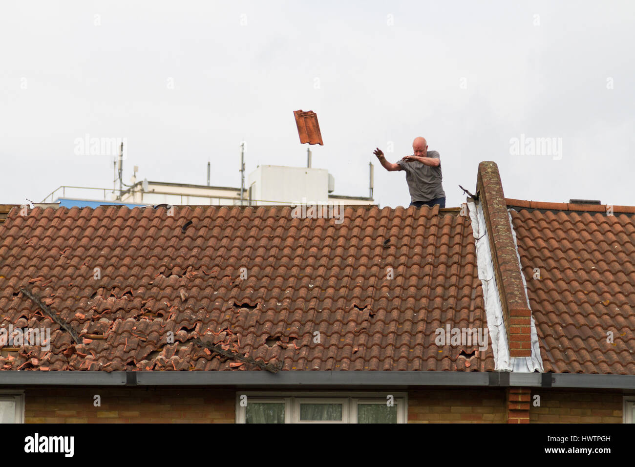 Police were called to an incident as a man on a roof was throwing roof ...