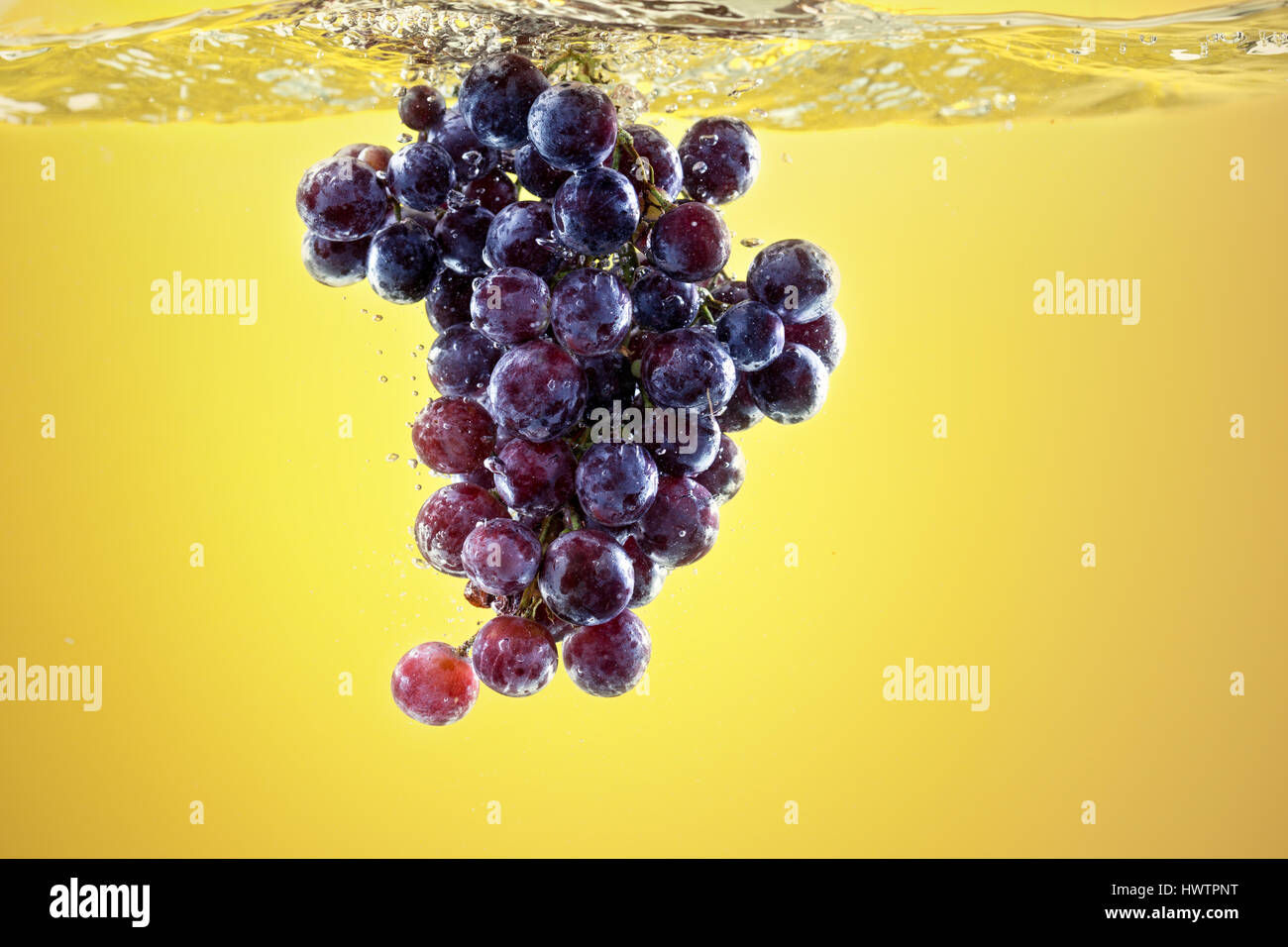 grapes splashing in tank of water background Stock Photo - Alamy