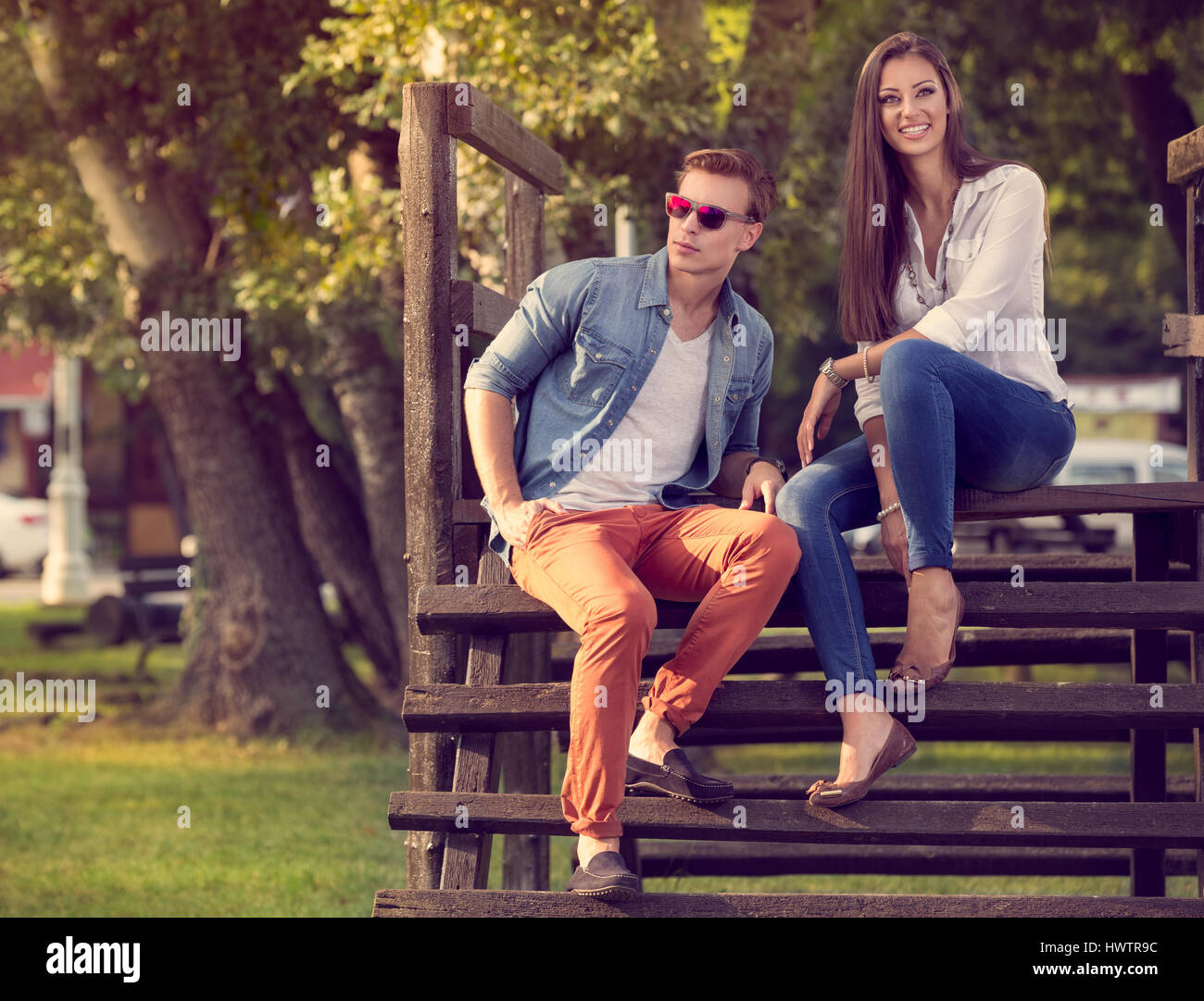 Young beautiful couple in nature, sitting and relaxing Stock Photo - Alamy