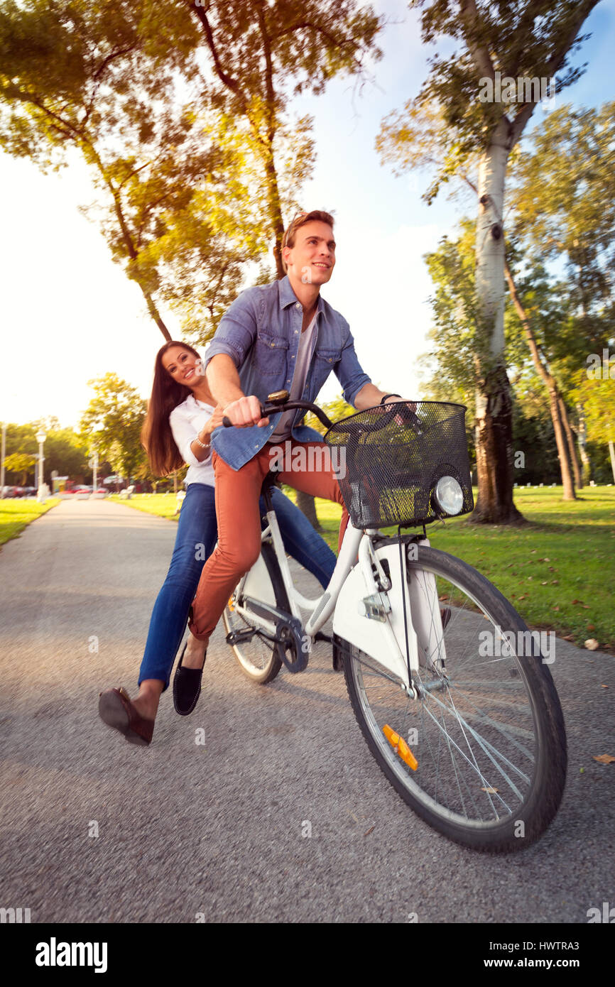 Cute young couple riding bicycle hi-res stock photography and images ...