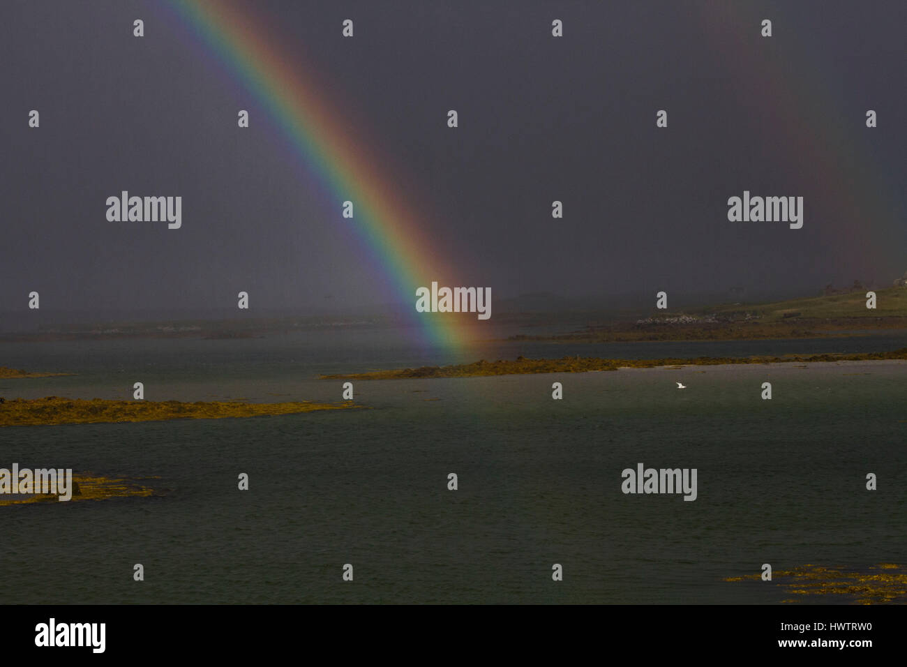 Rainbow on sea loch Stock Photo - Alamy