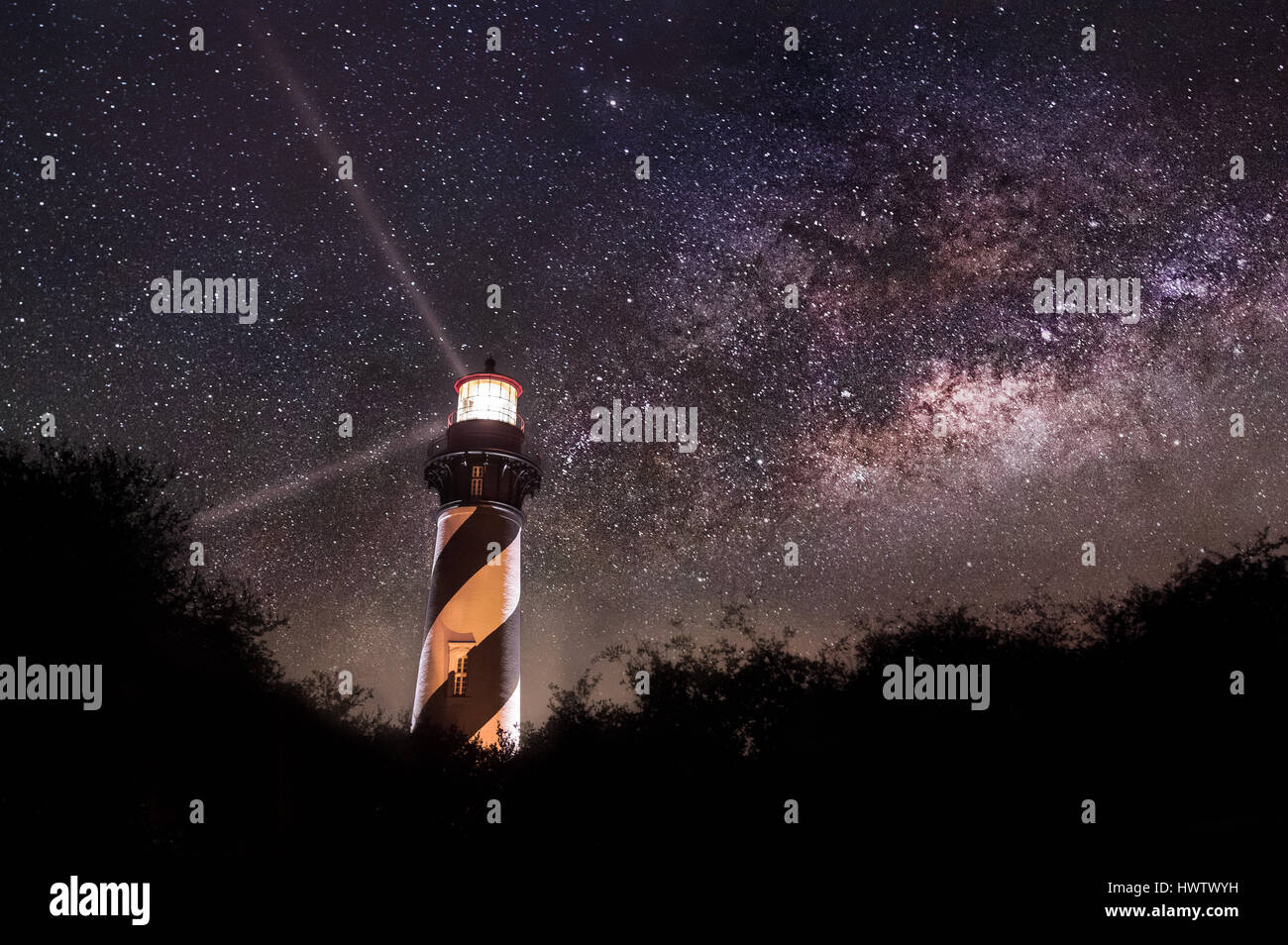 The lighthouse of St. Augustine, Florida beams brightly in the night ...