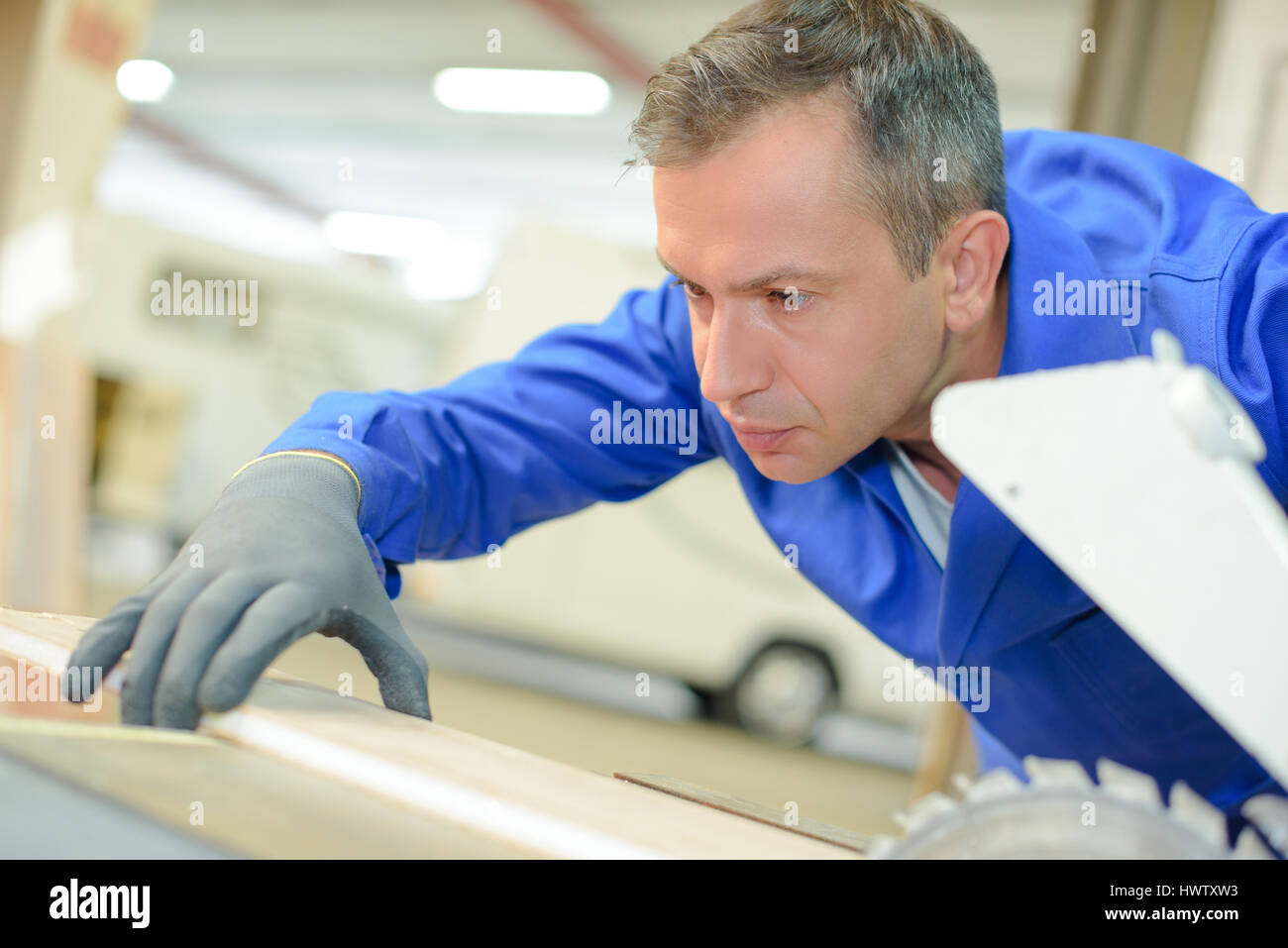Mature carpenter sawing hi-res stock photography and images - Alamy